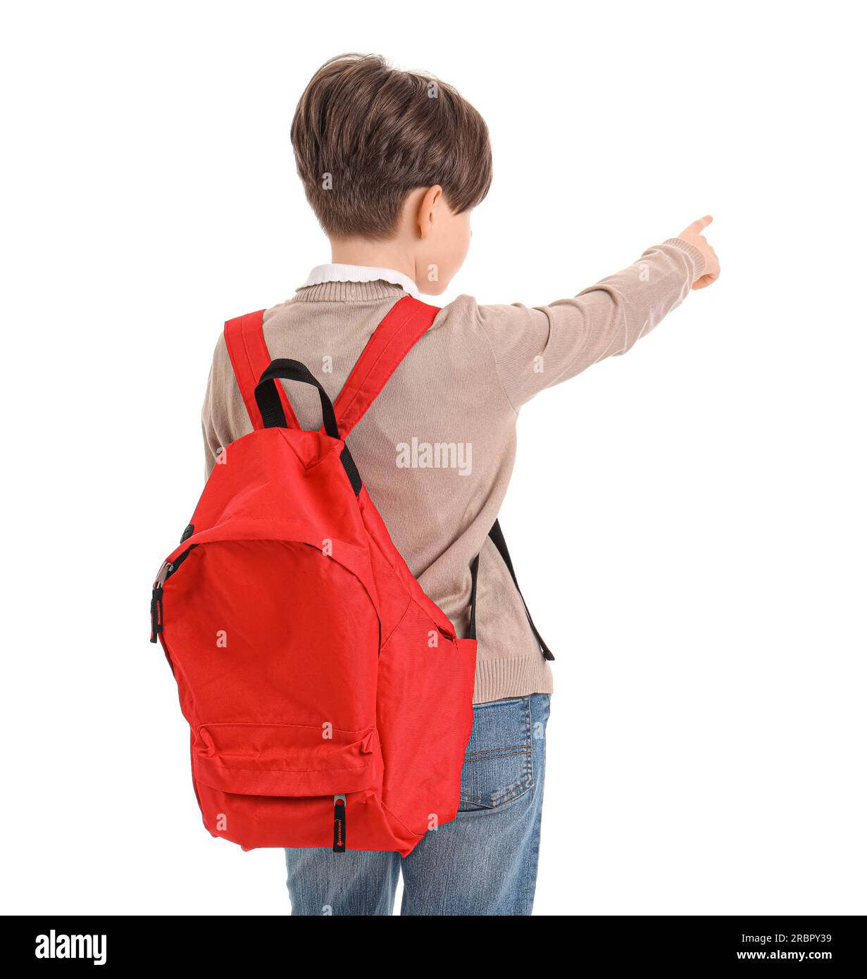 Little boy with schoolbag pointing at something on white background ...
