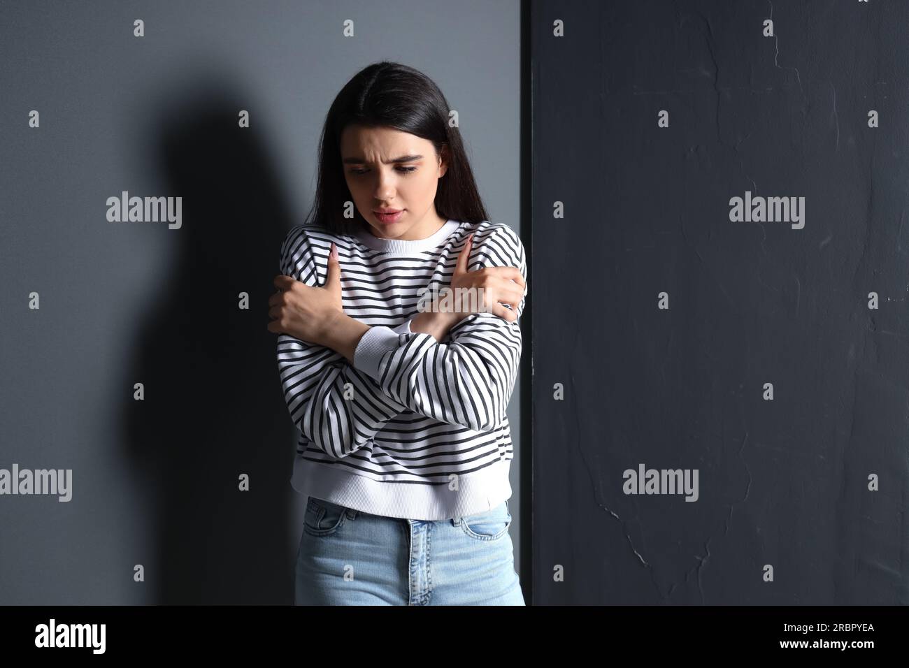 Young woman having panic attack indoors Stock Photo - Alamy
