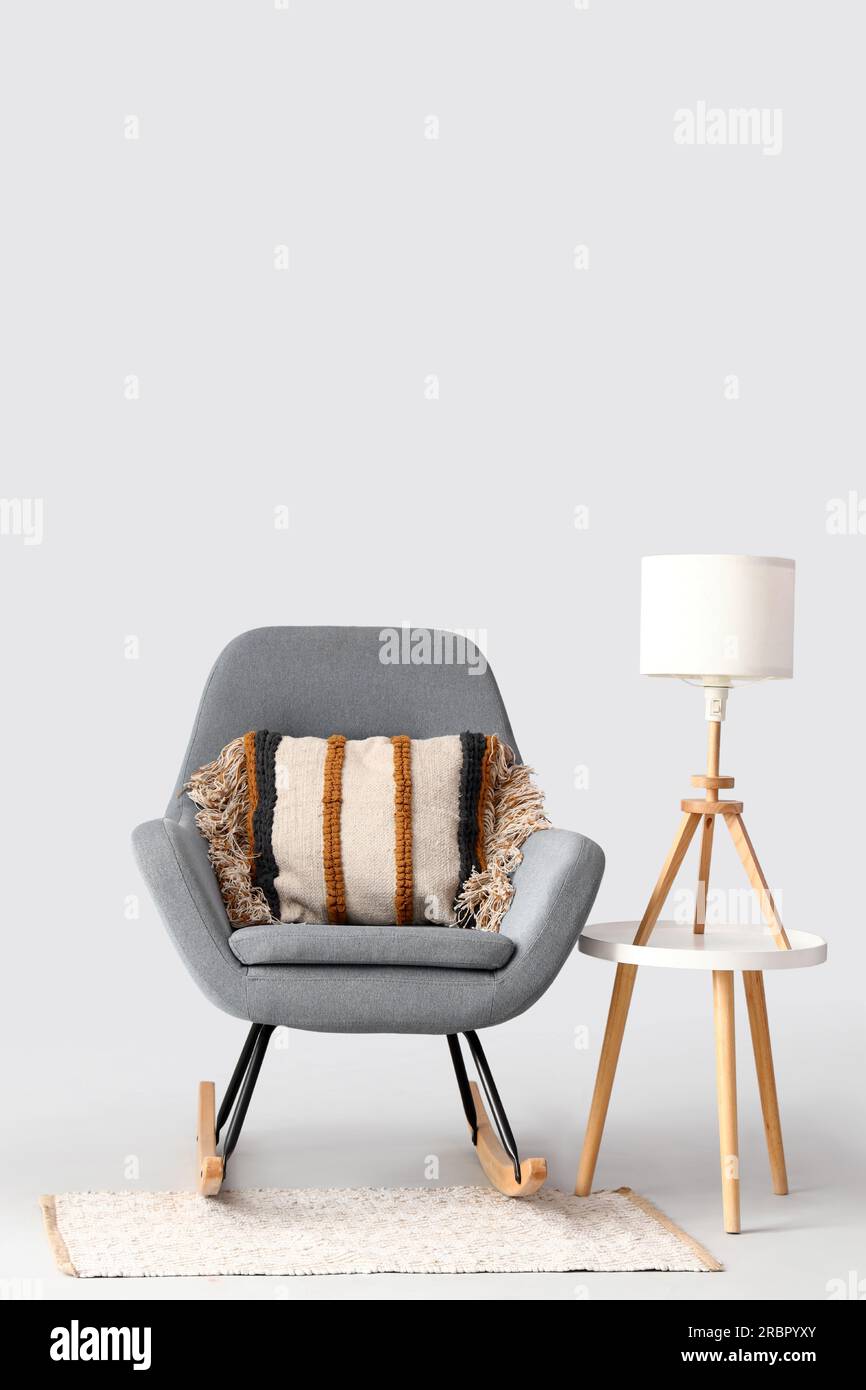 Rocking chair with table and rug on white background Stock Photo - Alamy