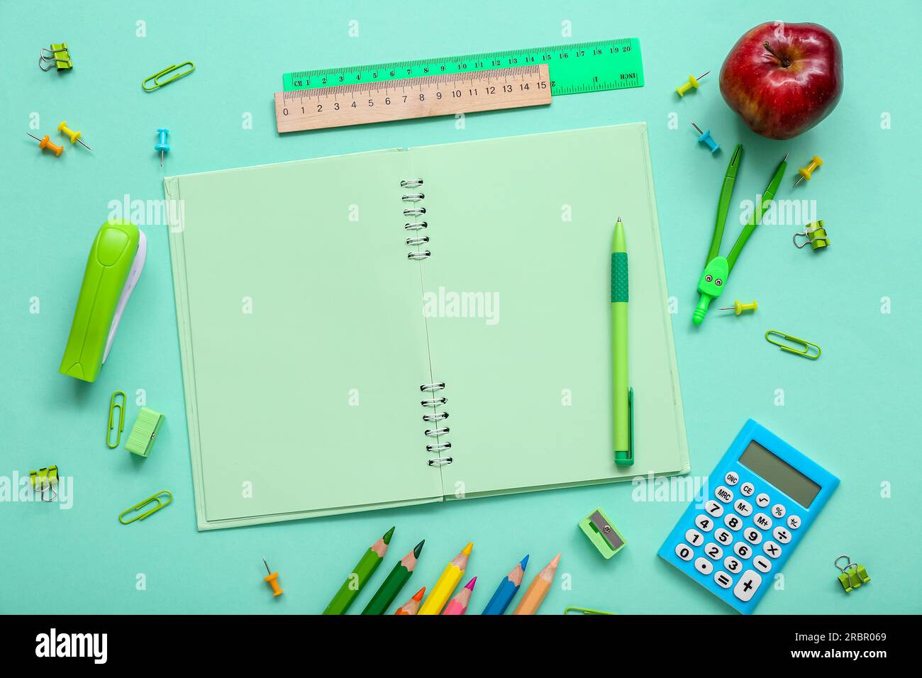 Blank notebook with fresh apple, calculator and different stationery on ...