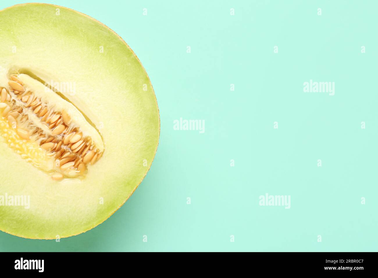 Half of sweet melon on turquoise background Stock Photo - Alamy