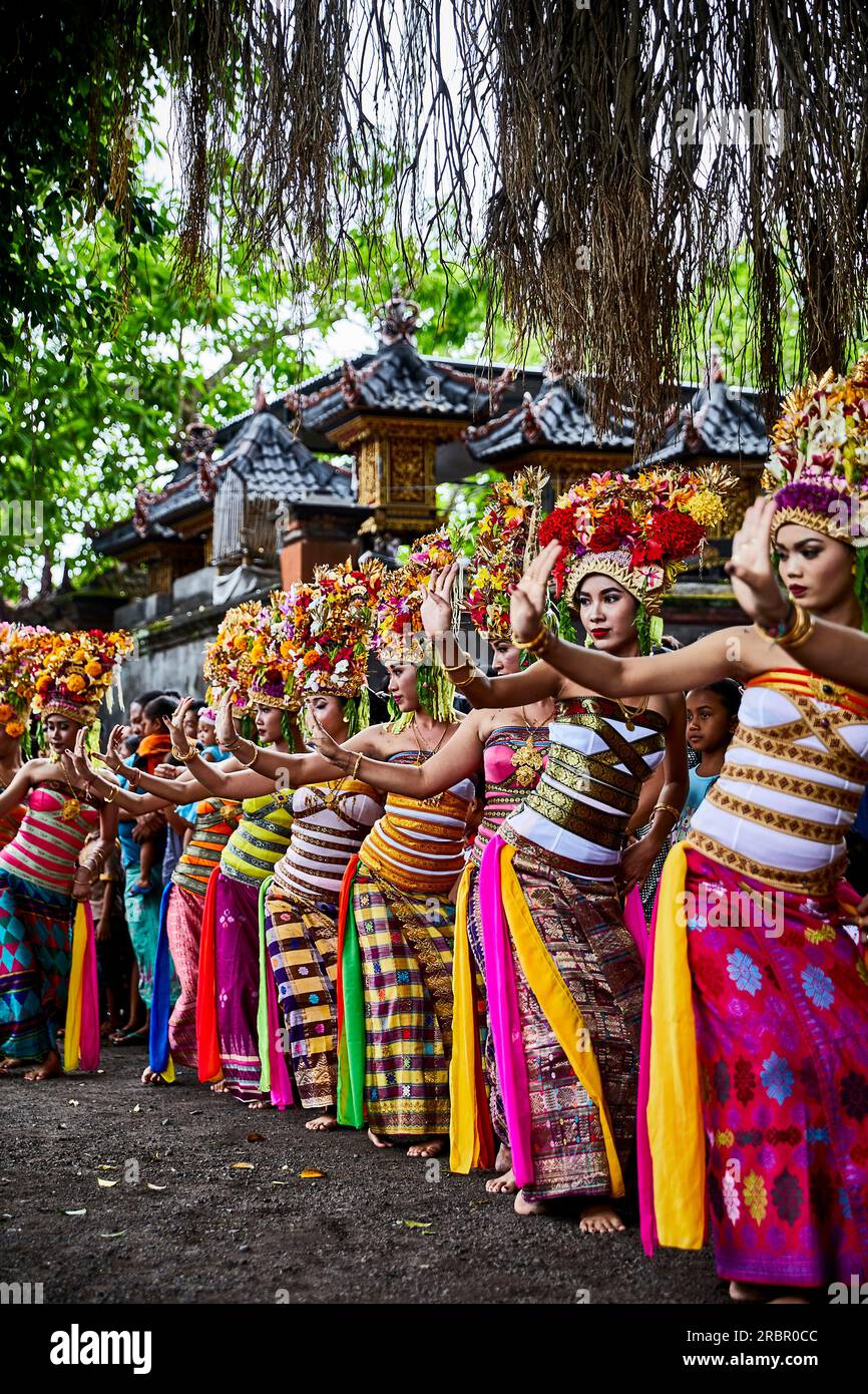A colourful procession of village young women in traditional dress ...