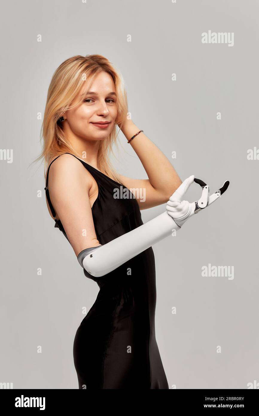 Studio portrait of beautiful young blonde girl with disability wearing ...