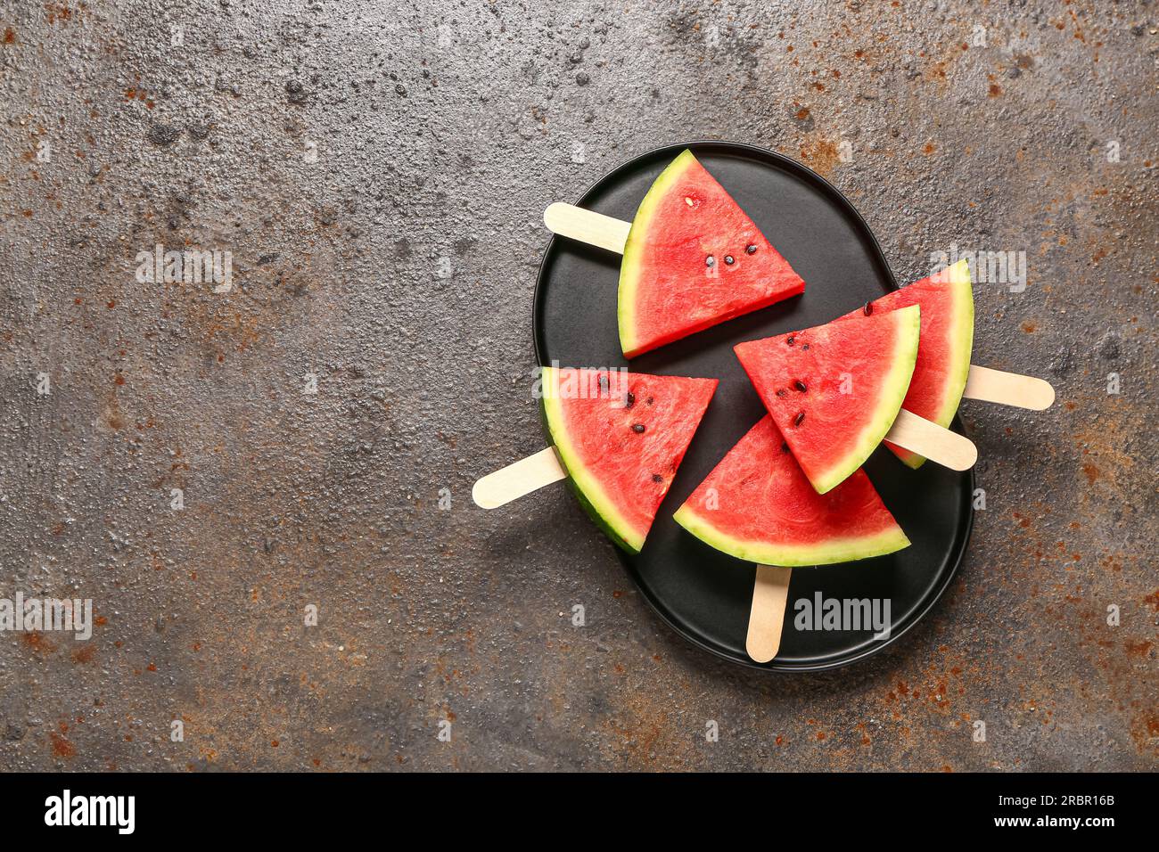 Tray with sweet watermelon sticks on dark background Stock Photo - Alamy