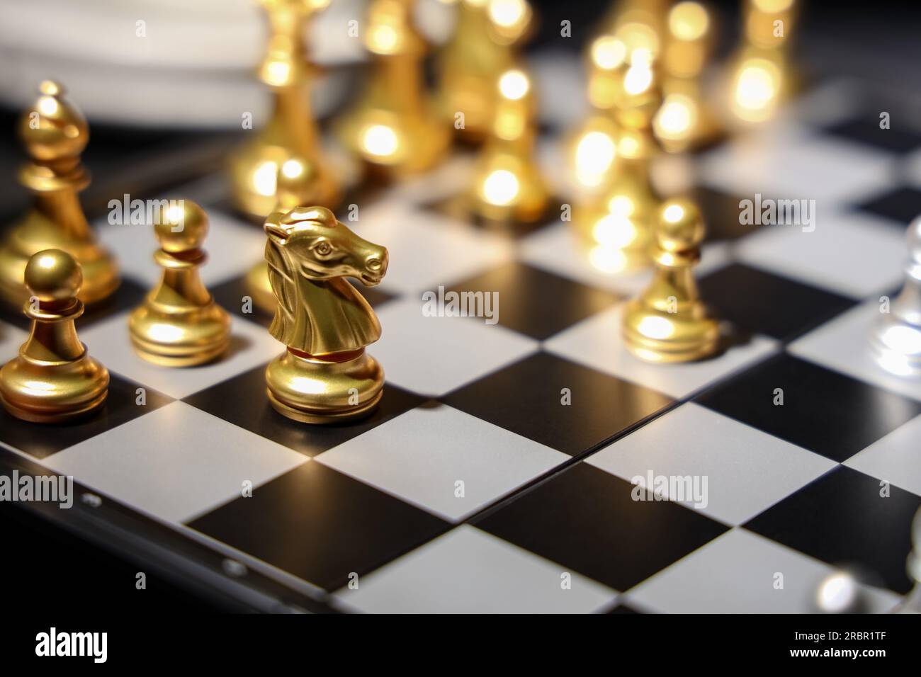 Golden chess pieces on game board, closeup Stock Photo - Alamy