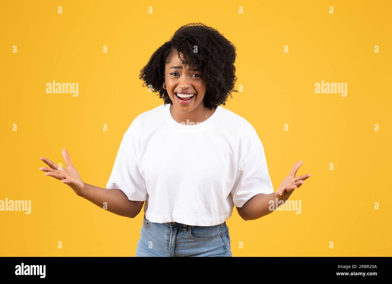 Happy laughing surprised millennial black lady in casual spread arms to ...
