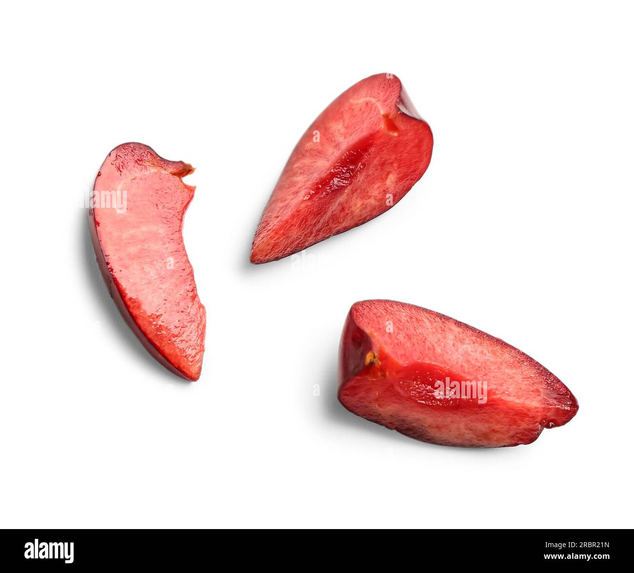 Pieces of red sweet cherry on white background Stock Photo - Alamy