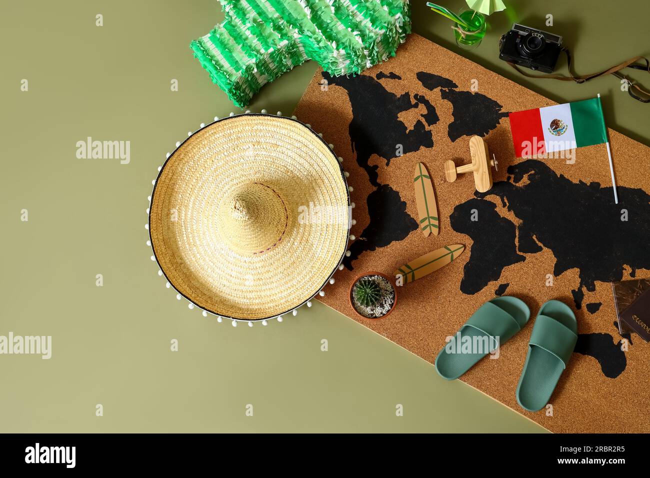 Pinata with map, Mexican flag and beach accessories on green background ...