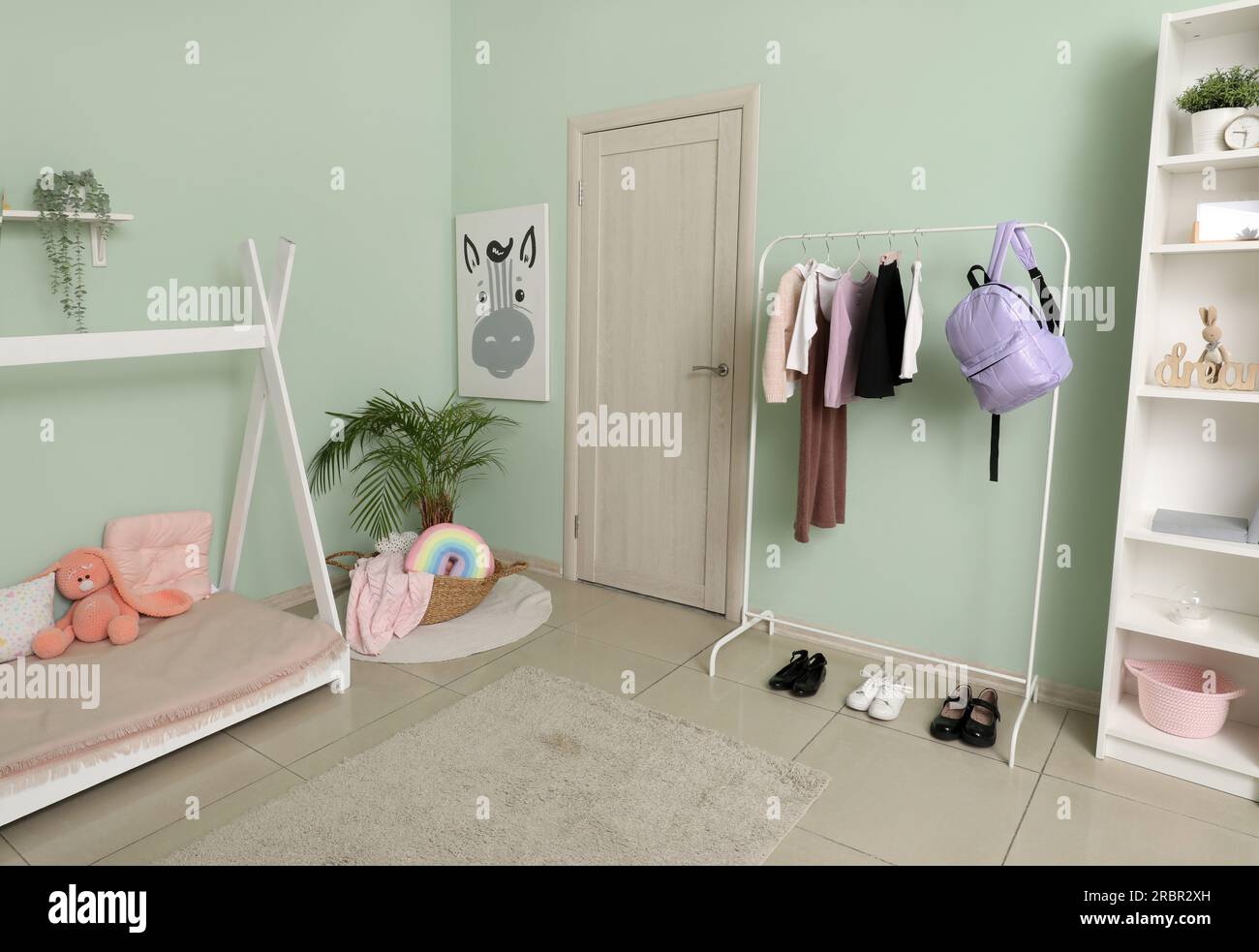 Stylish interior of children's bedroom with school uniform and backpack ...