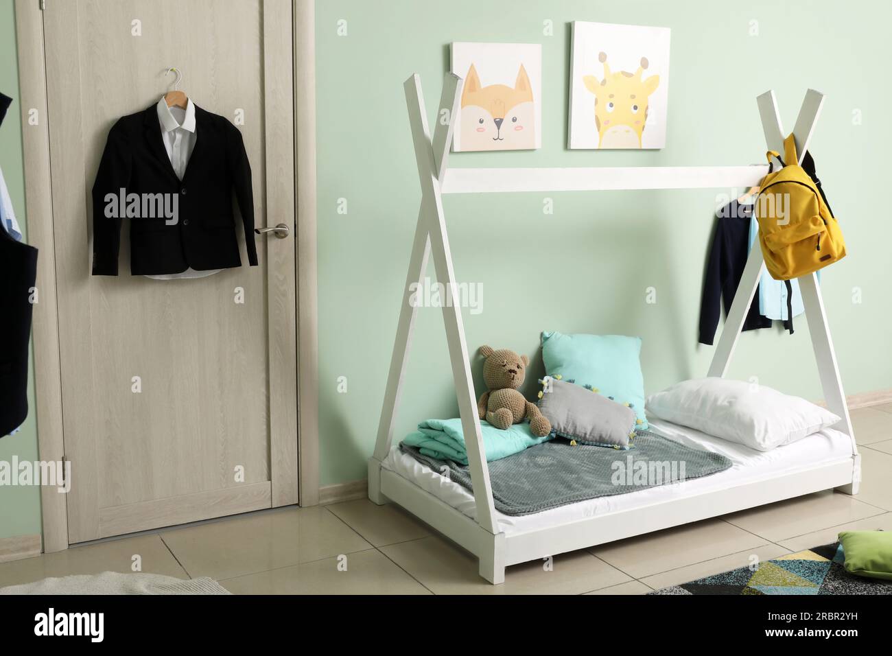 Stylish interior of children's room with comfortable bed and school ...