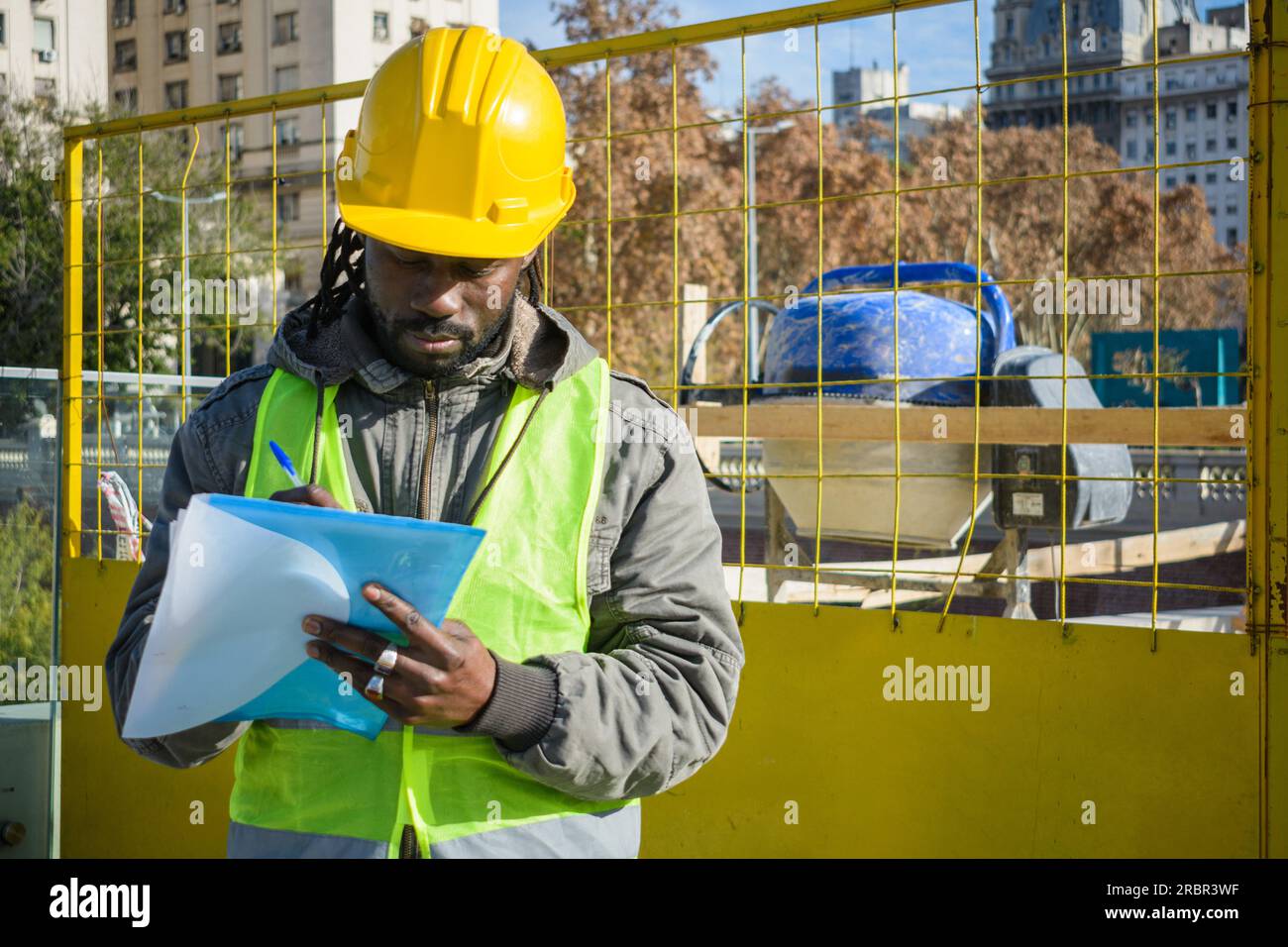 young black man of african ethnicity, wearing green vest jacket and ...
