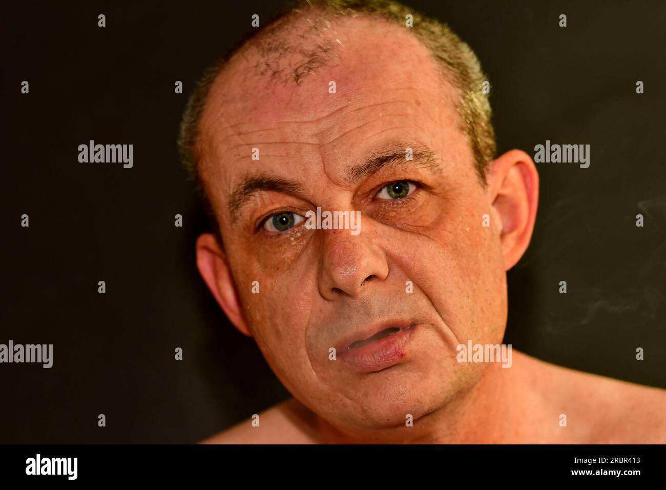 Old man on black background. Real photo Stock Photo - Alamy