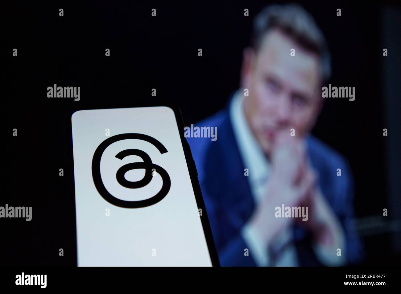 Threads and instagram app logo on screen, Twitter CEO Elon Musk in the background Stock Photo ...