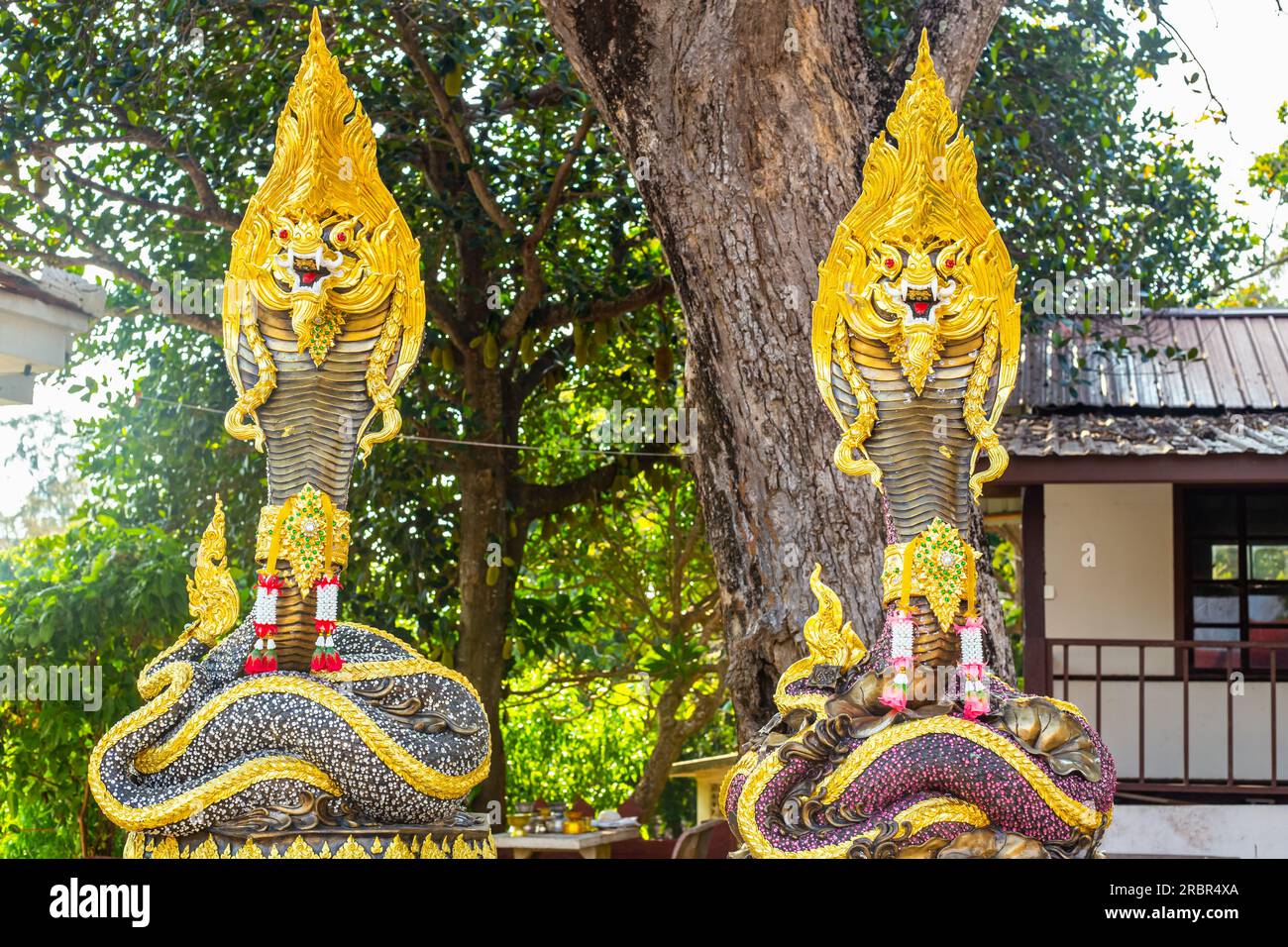 Painted ornate snake statues in a Buddhist temple. Culture of Asia ...