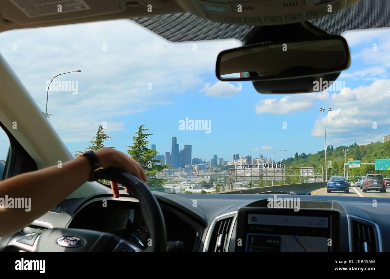 View of the city skyline from inside a car driving north on Interstate ...