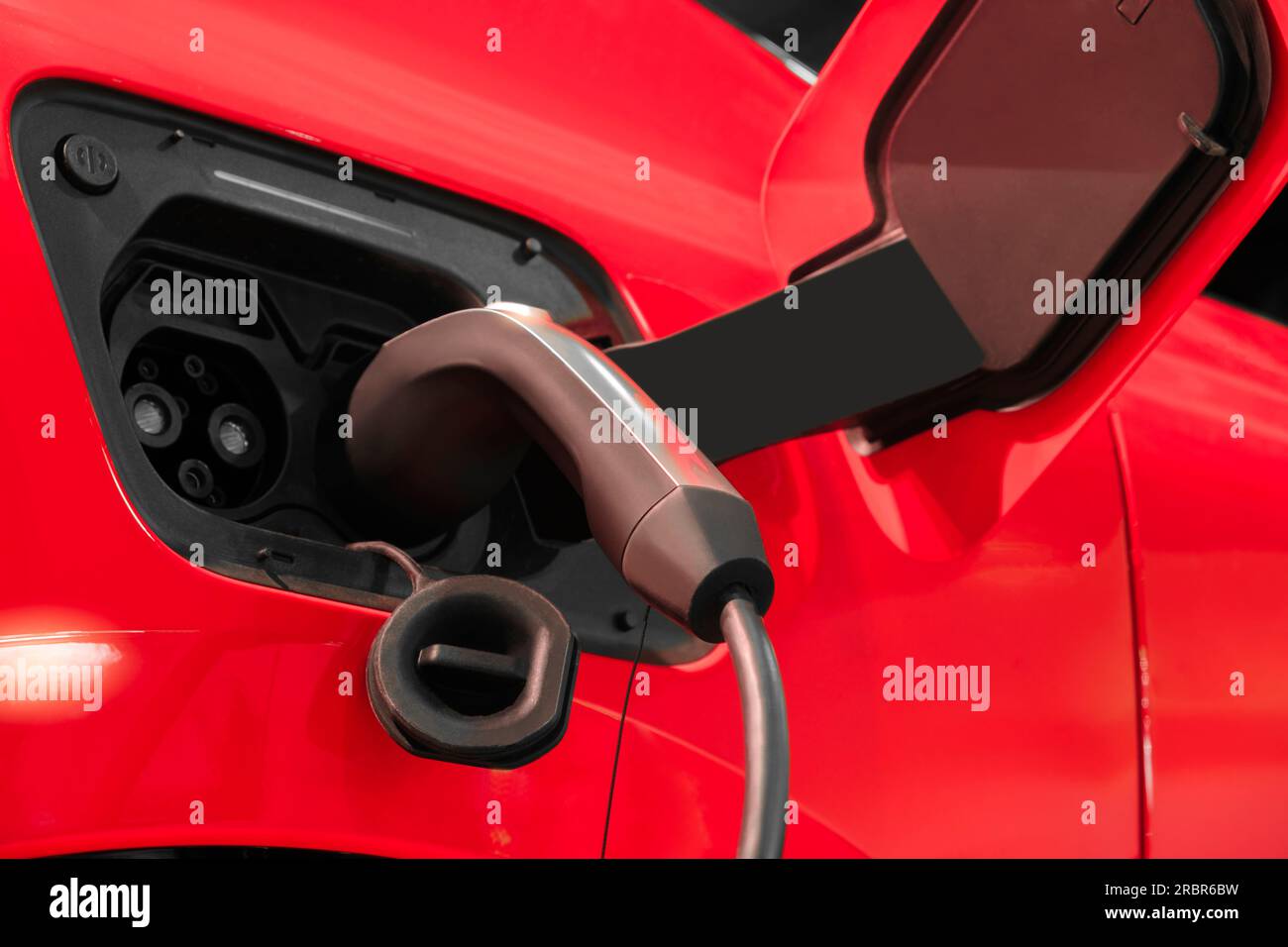 EV charging station for red electric car in concept of green energy and ...