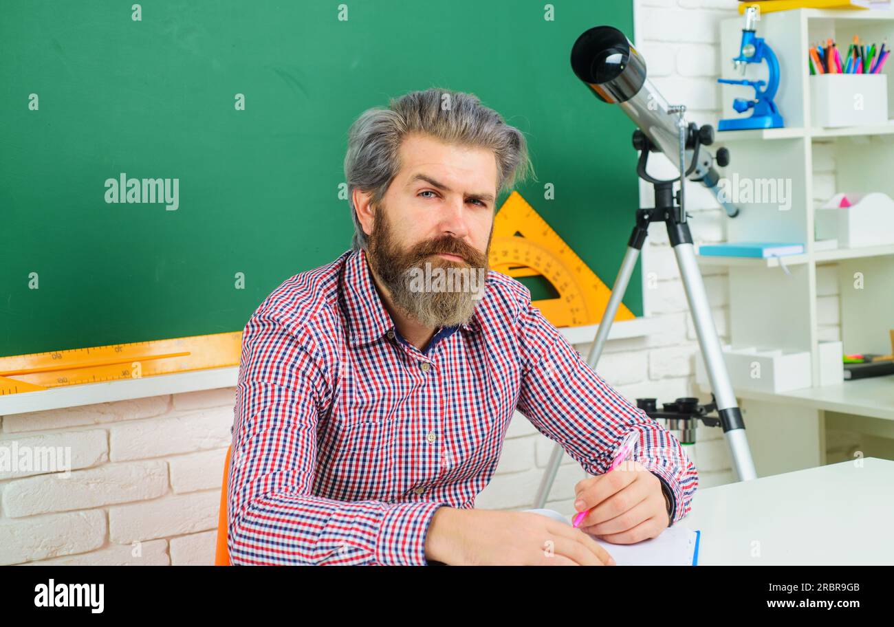 Serious bearded teacher or student in classroom. Learning, education ...