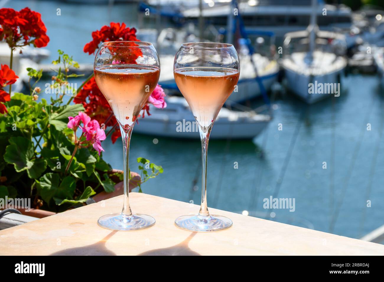 Summer party, drinking of French brut rose champagne sparkling wine in ...