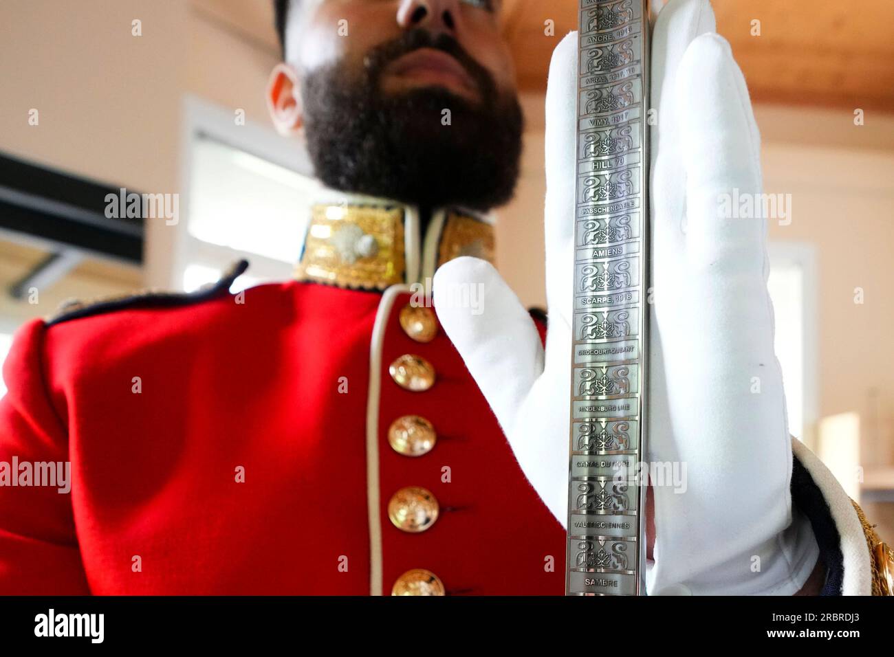 Ens. Jean Murad displays his sword which is detailed with the names of past battles as the ...