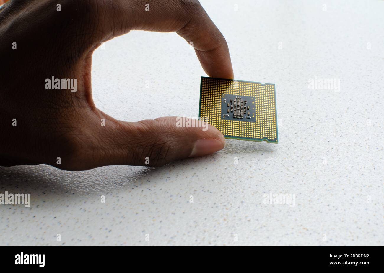 Hand holding a computer processor, symbol of advanced technology and ...