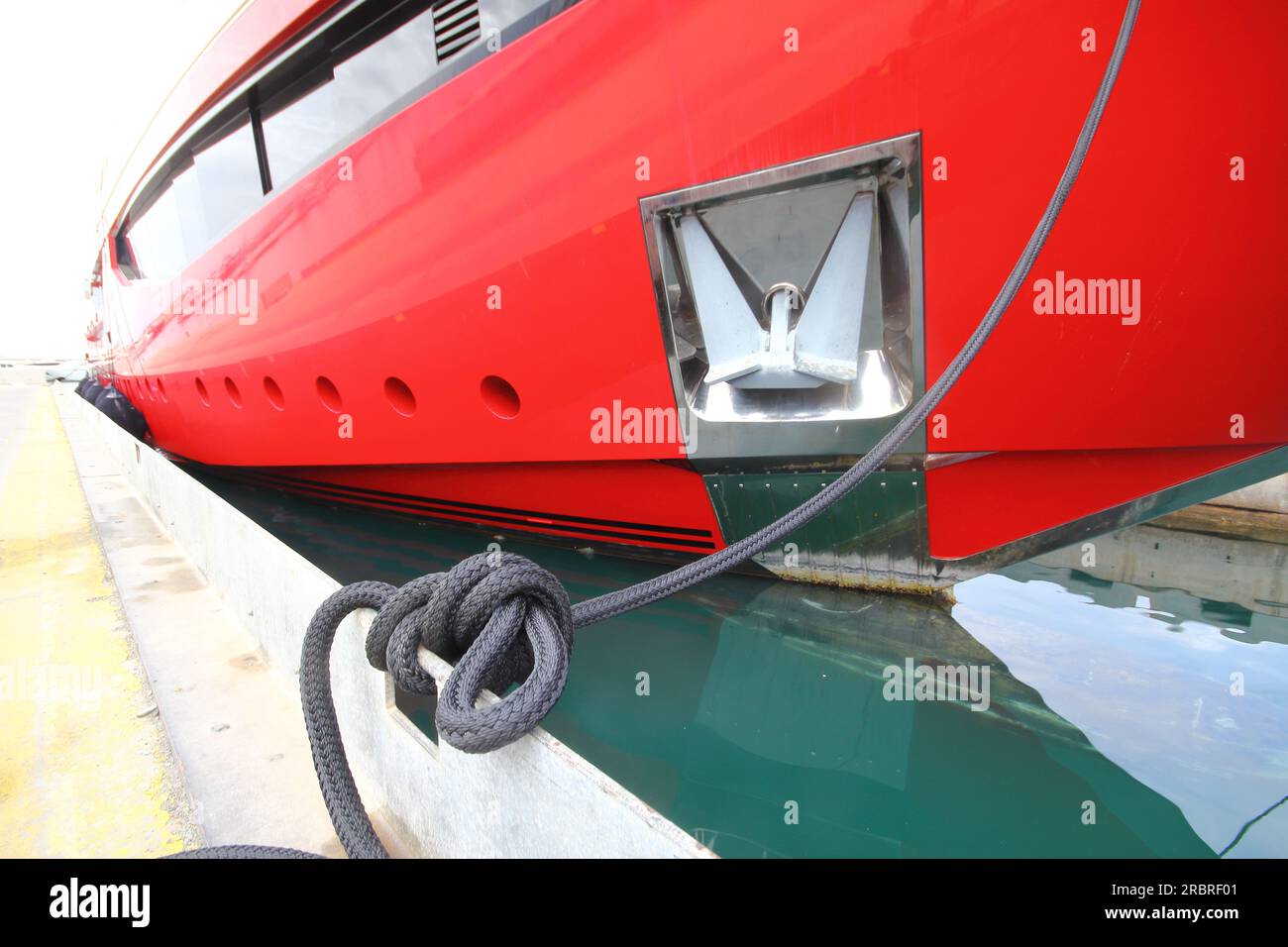 selective focus on rope anchoring mega yacht at the pier Stock Photo ...