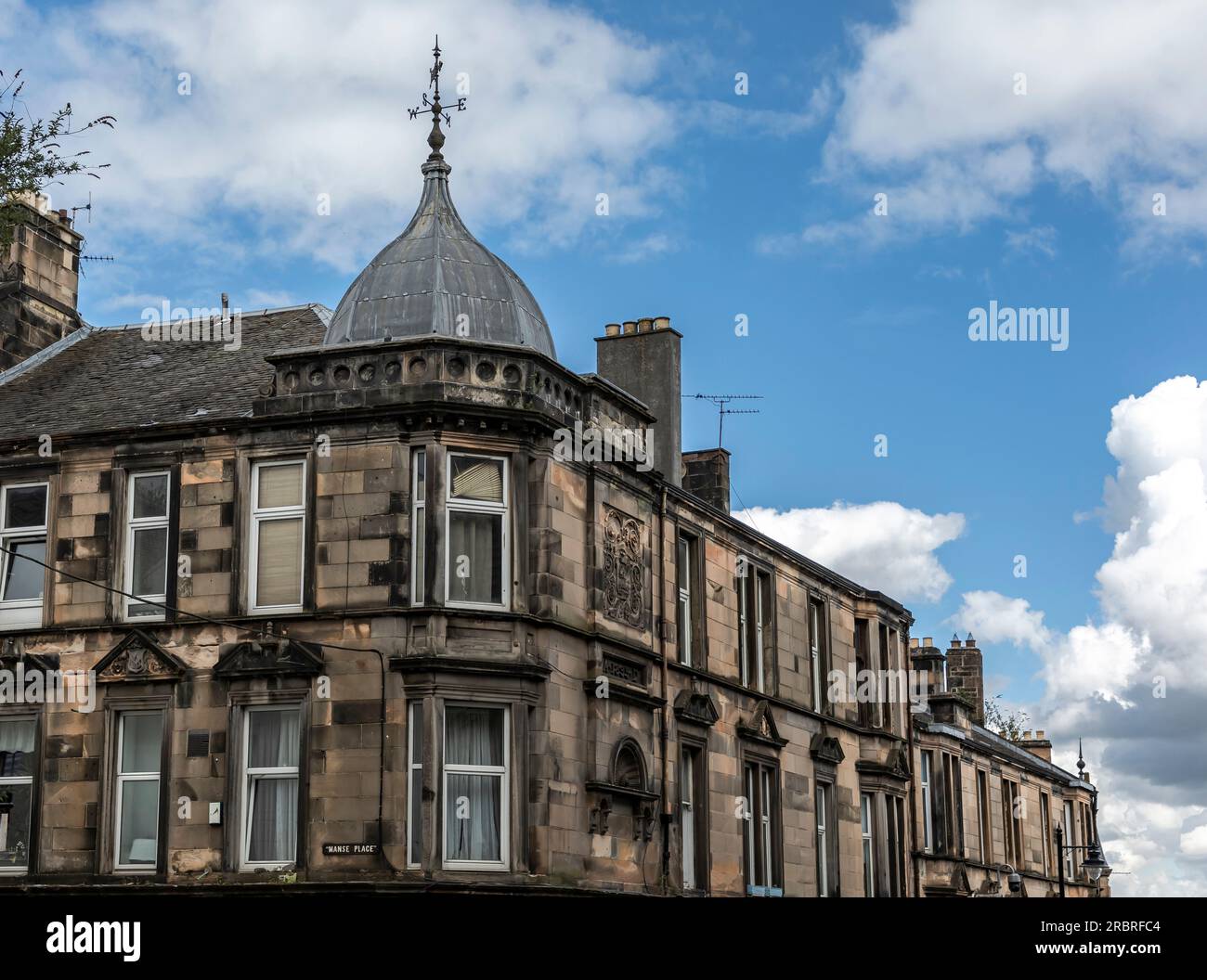 Old Scottish corner building made of sandstone blocks with a lead roof ...
