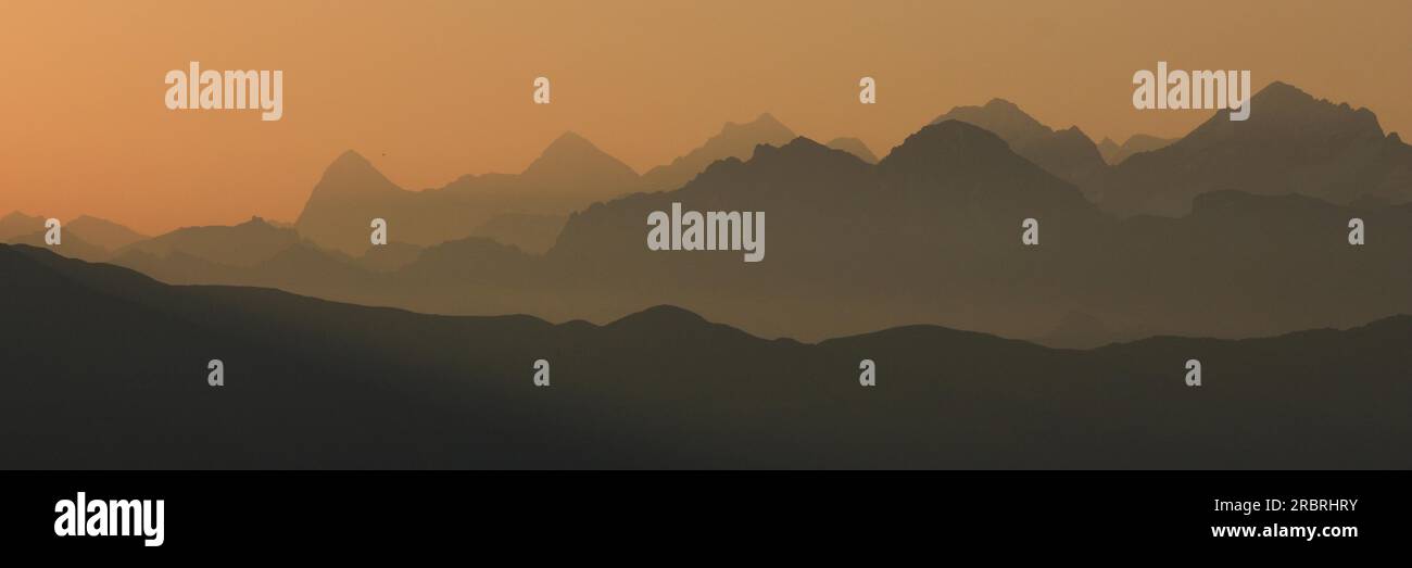 Mountain ranges in the golden morning hour Stock Photo - Alamy