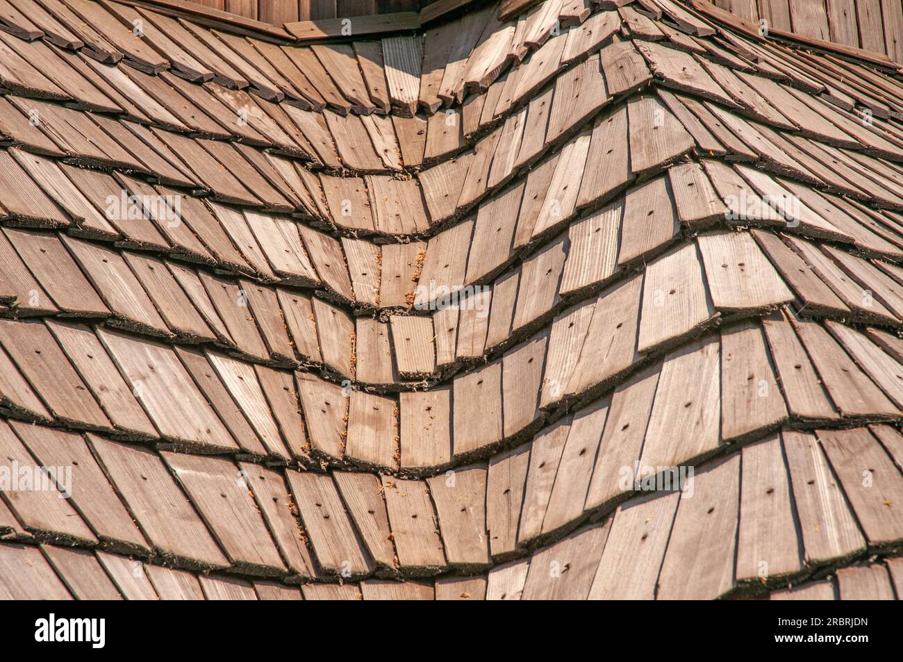 Roof made of wooden tiles under the sun.This typical Ukrainian and ...