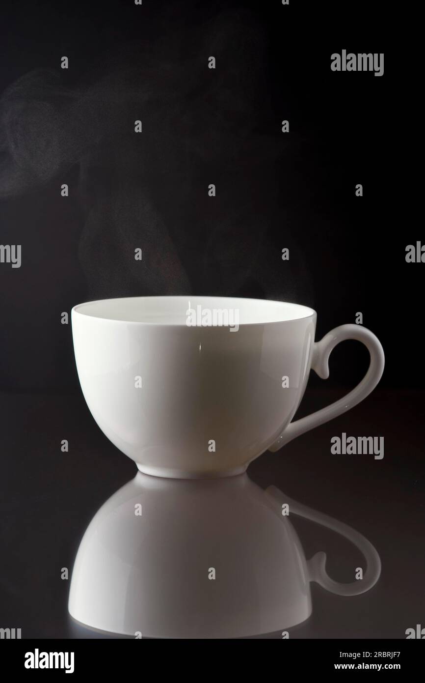 White cup on black background with reflection Stock Photo - Alamy