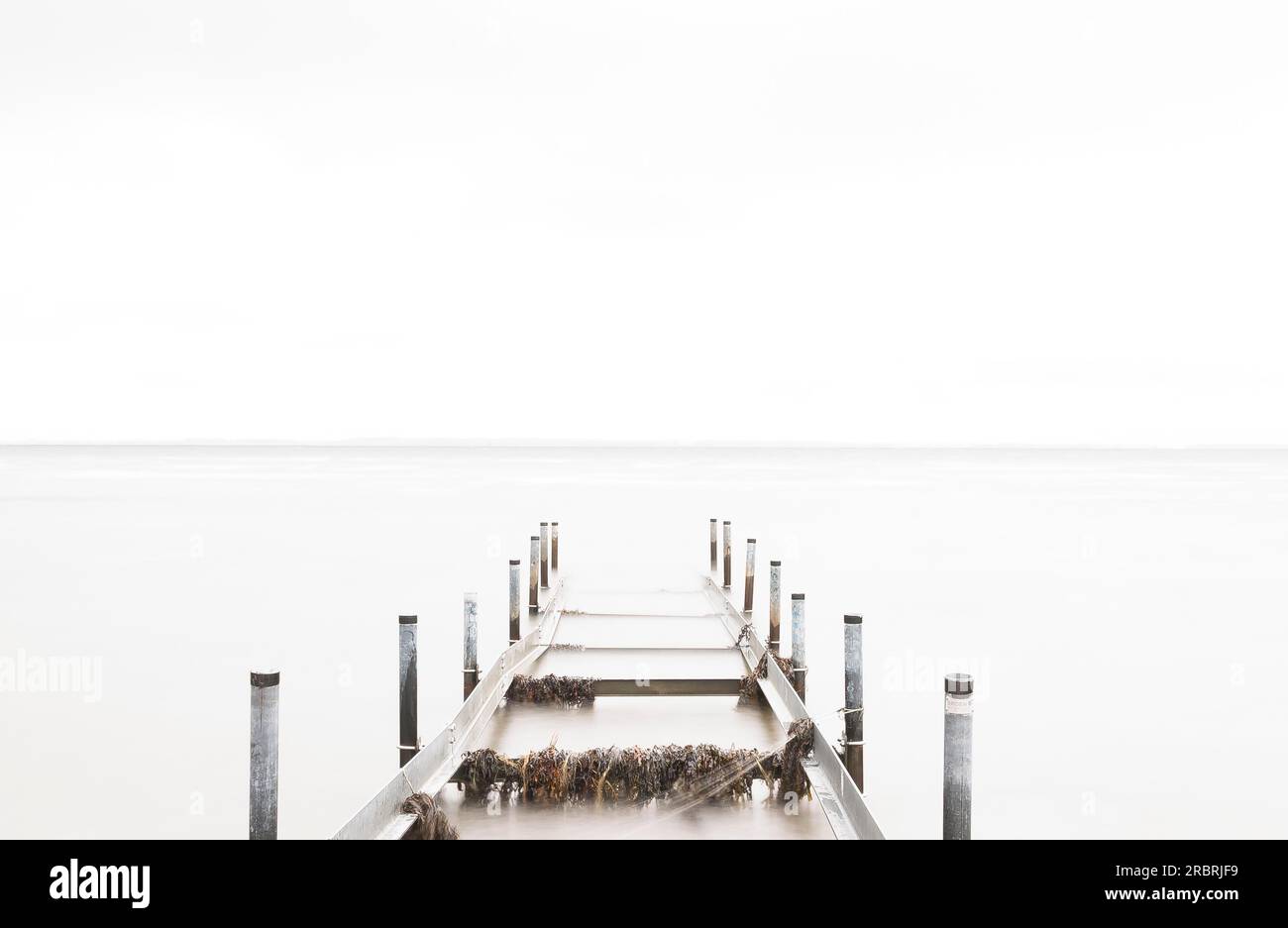 A high-key picture of a dismantled jetty in Binderup Strand, Denmark ...