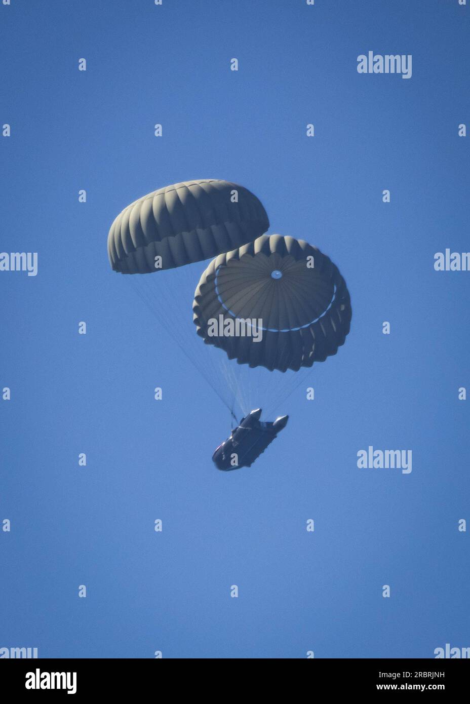 An Indonesian Marine Corps rubber boat parachutes down during the ...