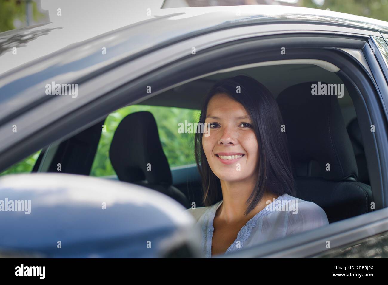Woman driving car and smile Stock Photo - Alamy
