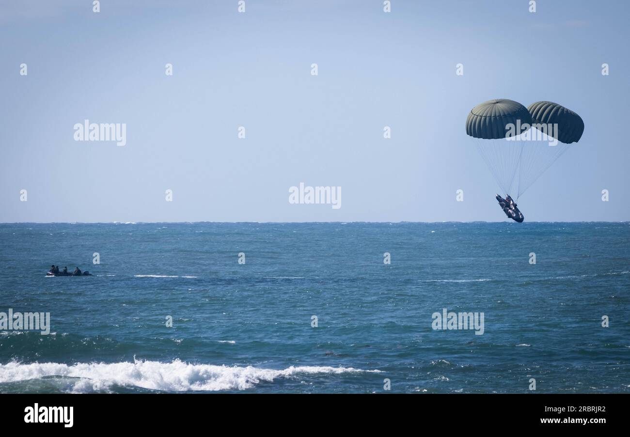 An Indonesian Marine Corps rubber boat parachutes down during the ...