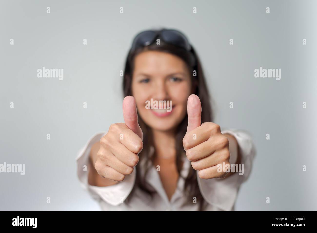 Woman making approval sign with her thumb Stock Photo - Alamy