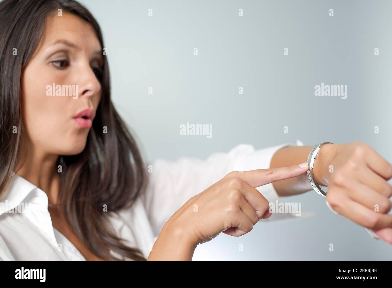 Woman indicating being too late Stock Photo - Alamy