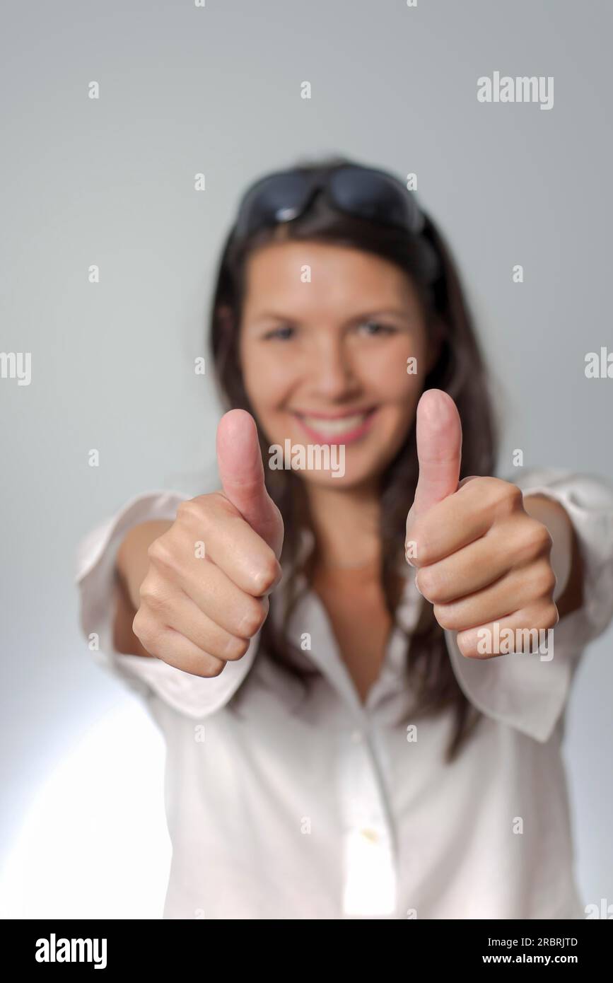 Woman making approval sign with her thumb Stock Photo - Alamy