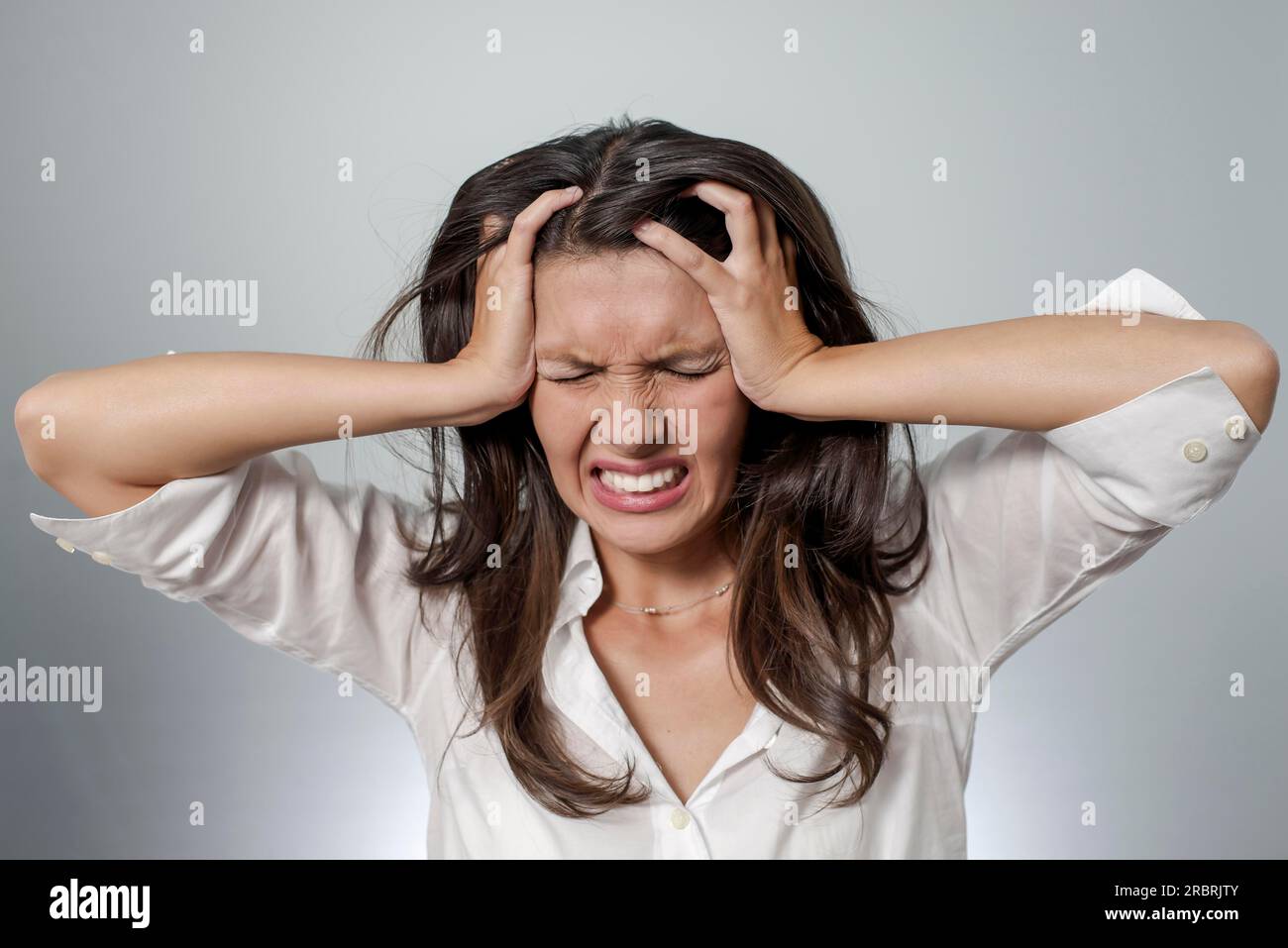 Woman with headache and negative face expression Stock Photo - Alamy