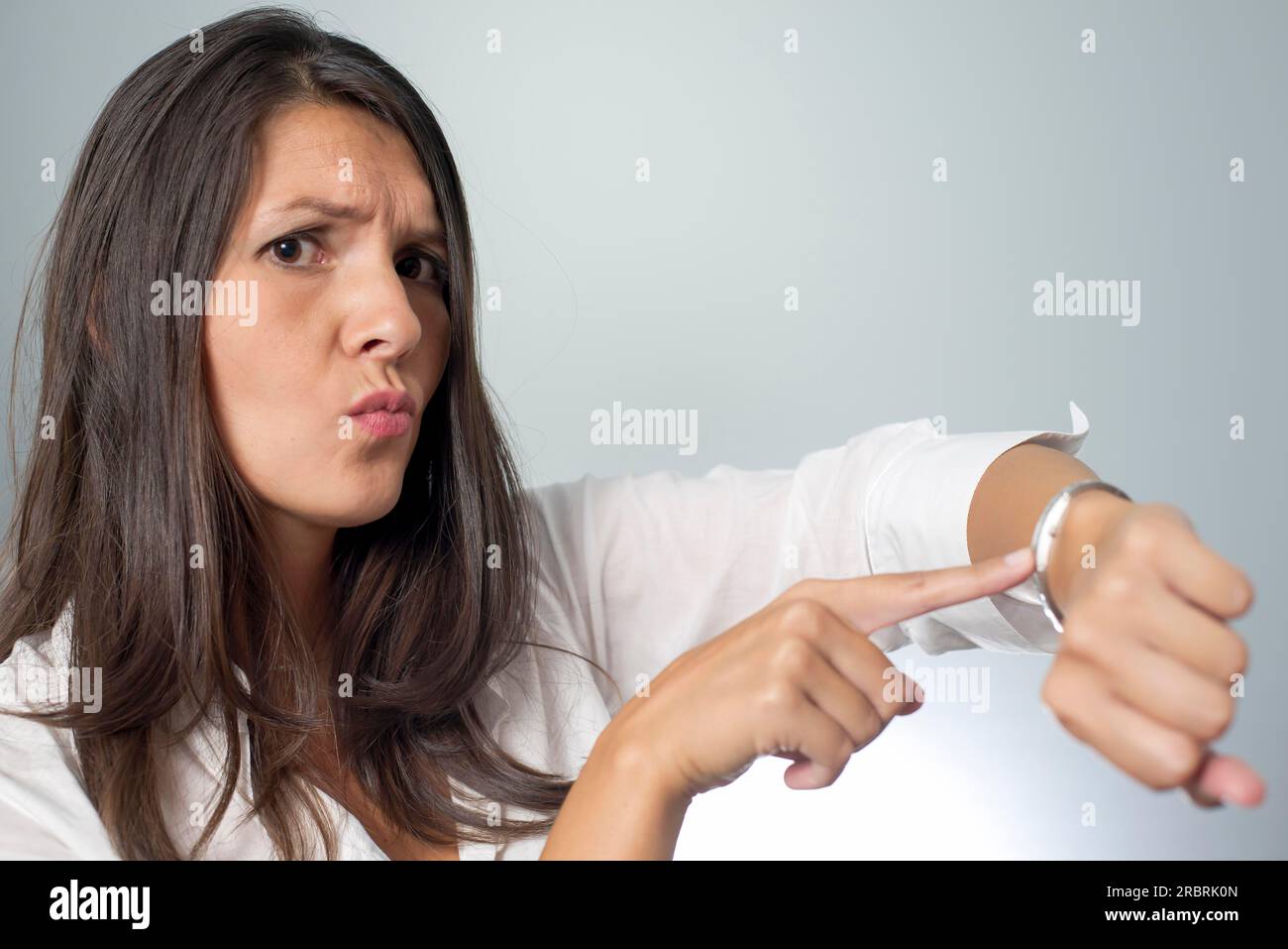 Woman indicating being too late Stock Photo - Alamy