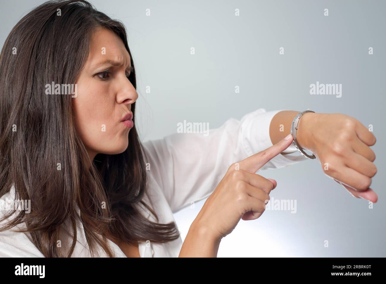 Woman indicating being too late Stock Photo - Alamy