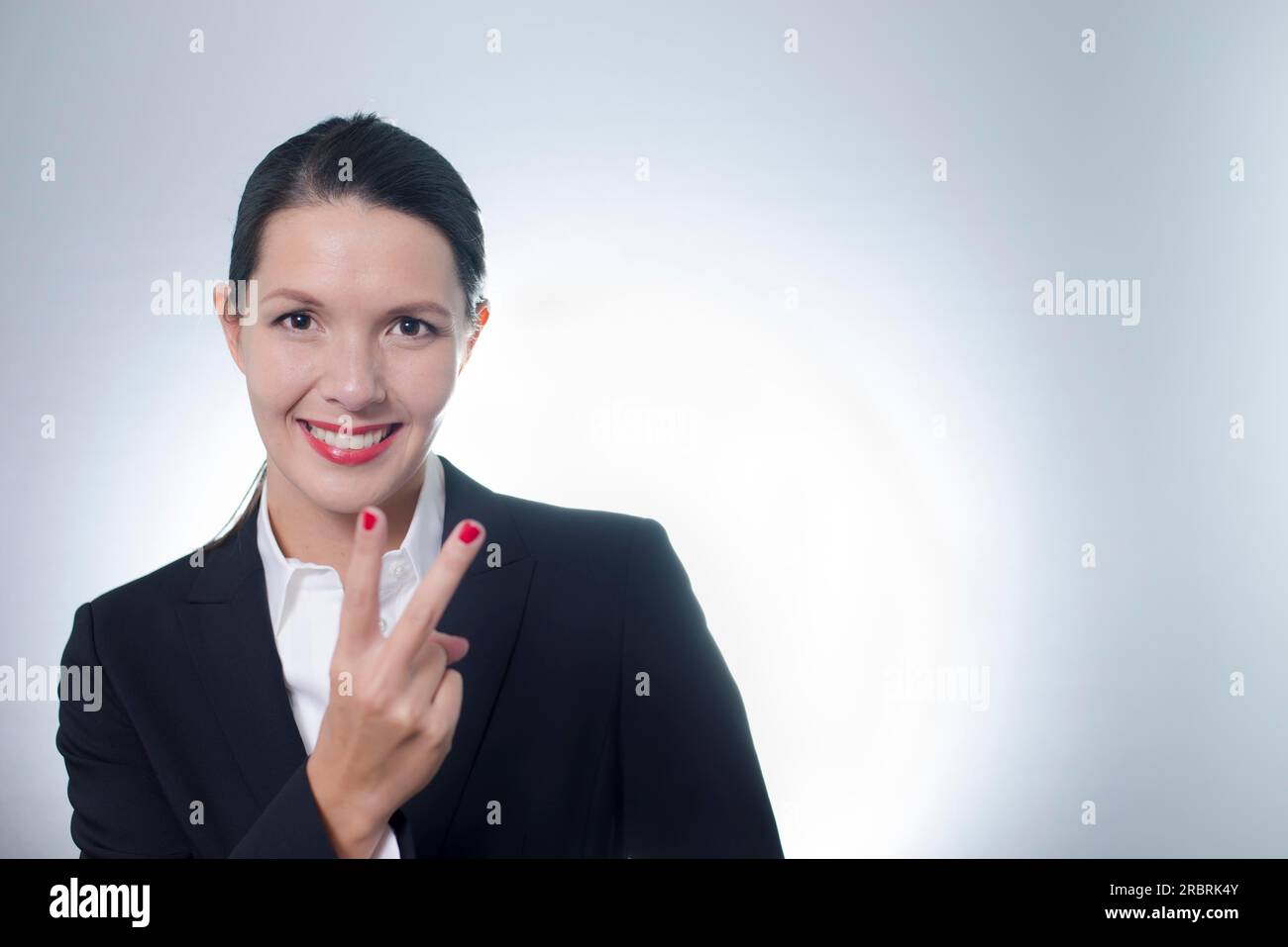 Beautiful jubilant young businesswoman cheering with a beaming ...