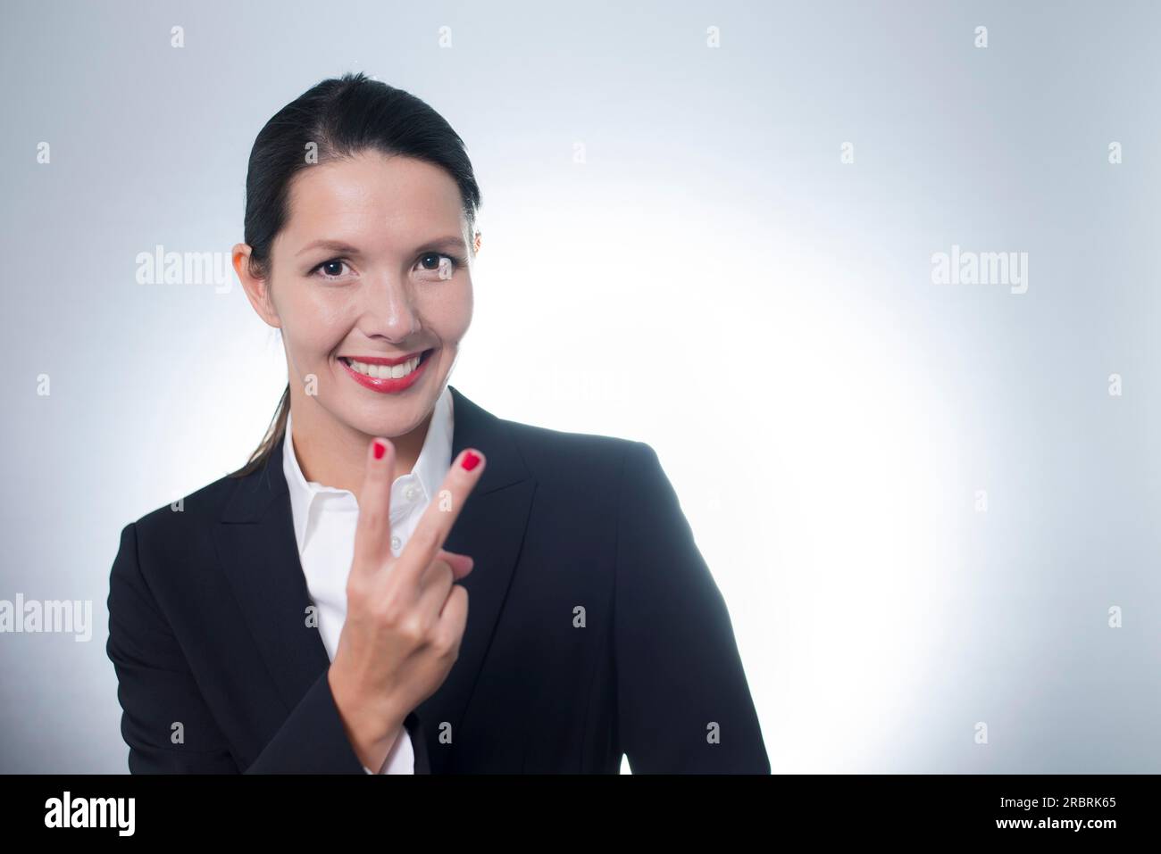 Beautiful jubilant young businesswoman cheering with a beaming ...