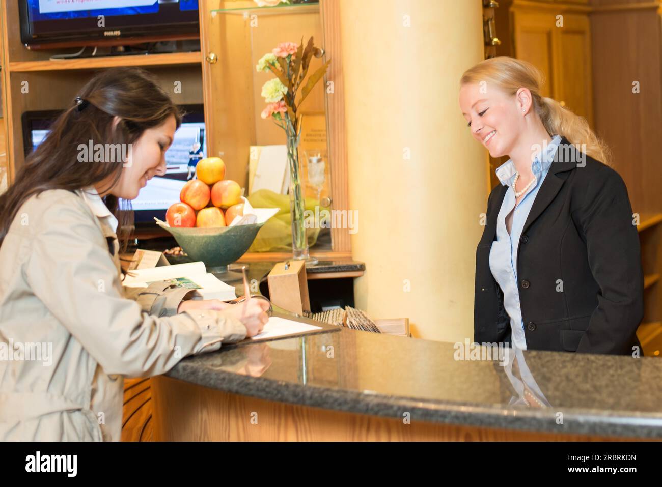 Woman check in counter hi-res stock photography and images - Alamy