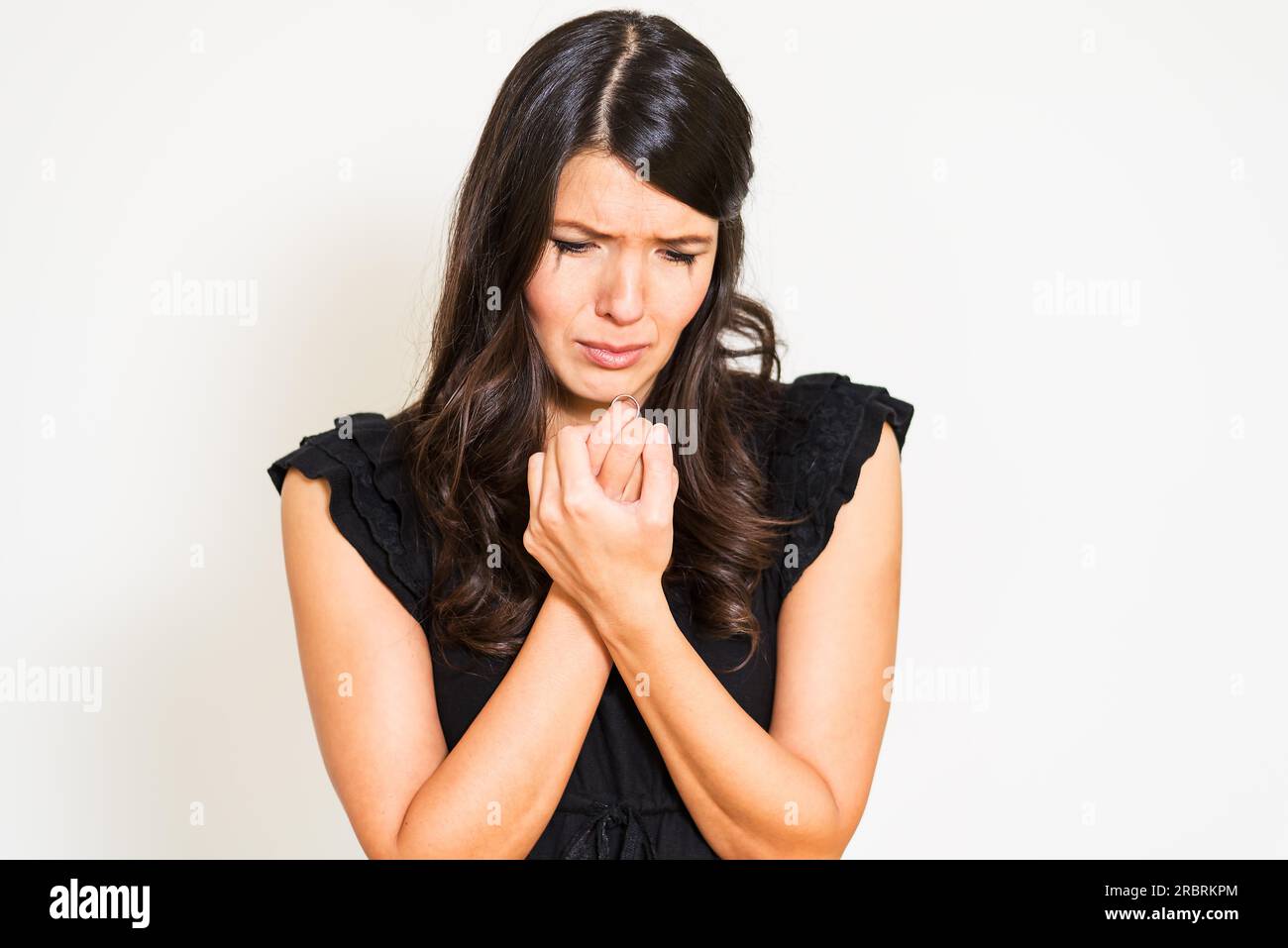 Attractive young tearful distressed woman with her eyes closed ...
