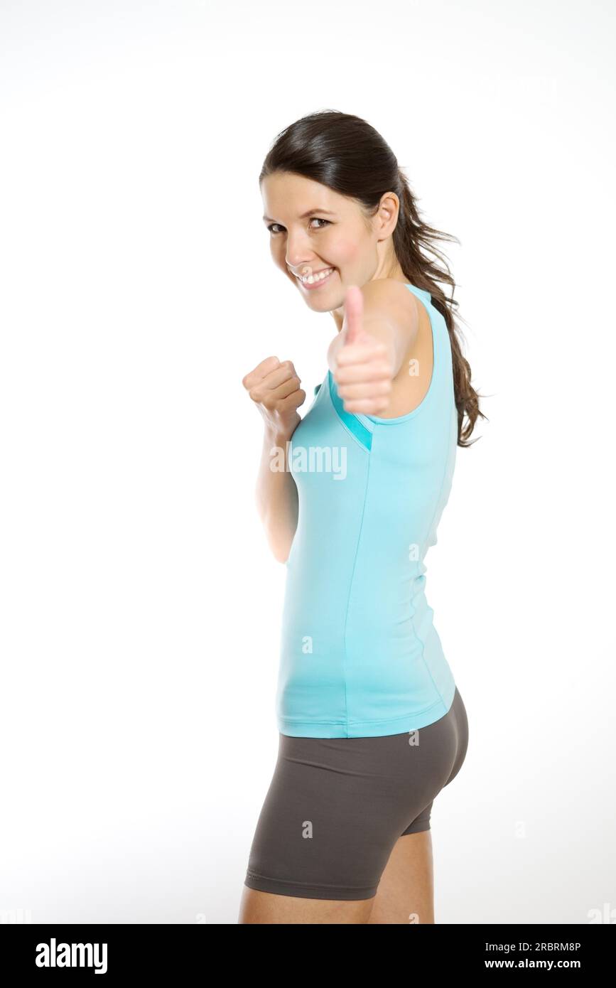Jubilant young woman rejoicing giving a thumbs up with a triumphant ...