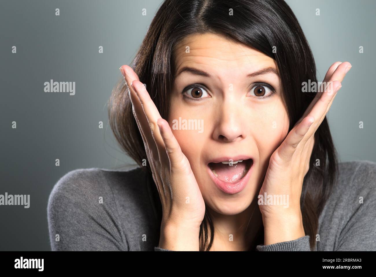 Attractive Woman Screaming In Terror With Her Hands To Her Cheeks