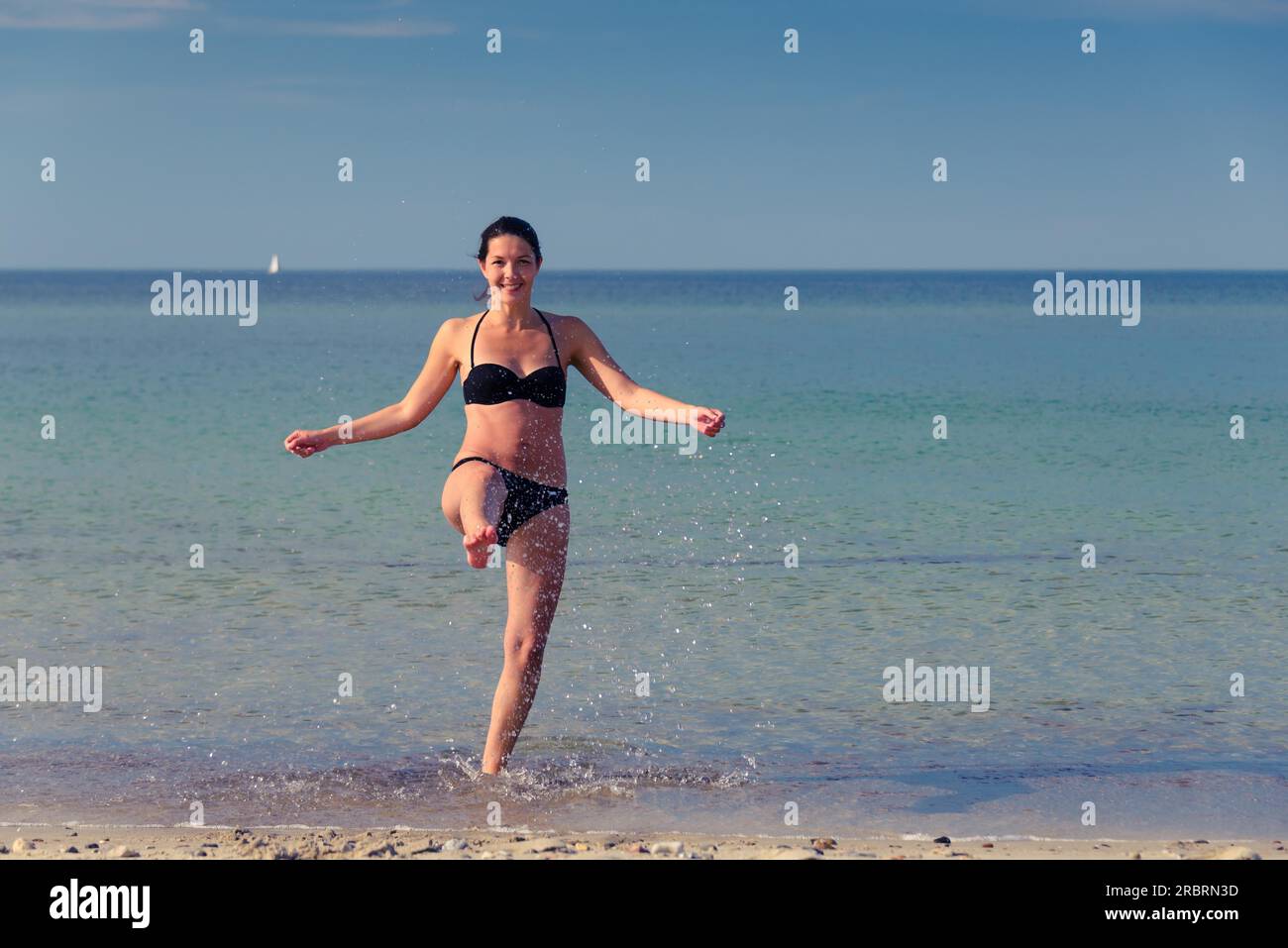 Woman bikini kick hi-res stock photography and images - Alamy