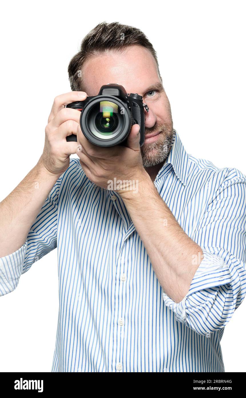 Male photographer focusing and composing an image with his professional ...