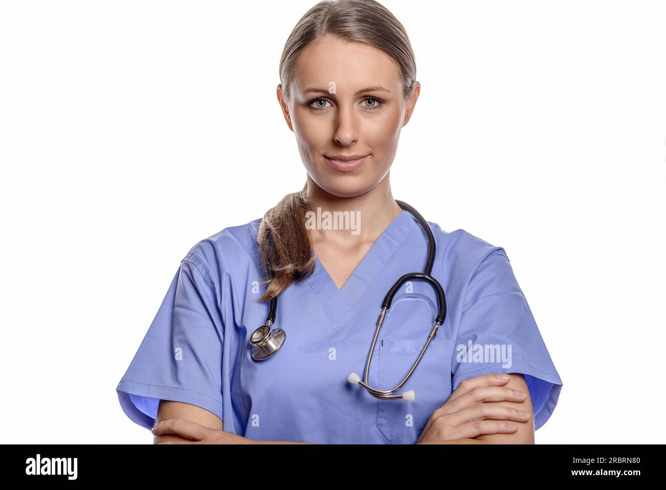 Portrait of a friendly young female physician wearing medical uniform ...