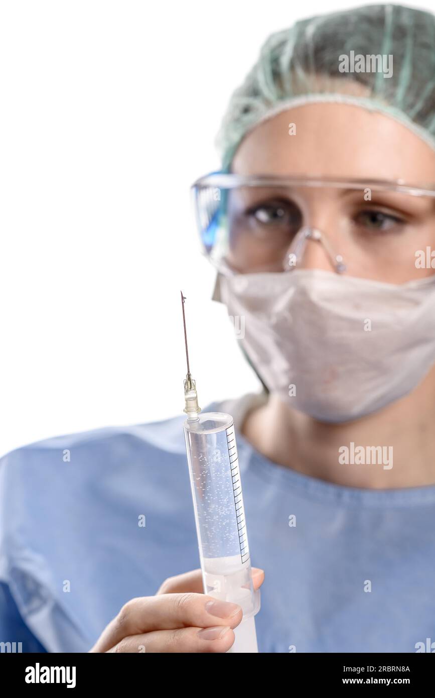 Close-up of the hands of a female doctor wearing a blue medical gown ...