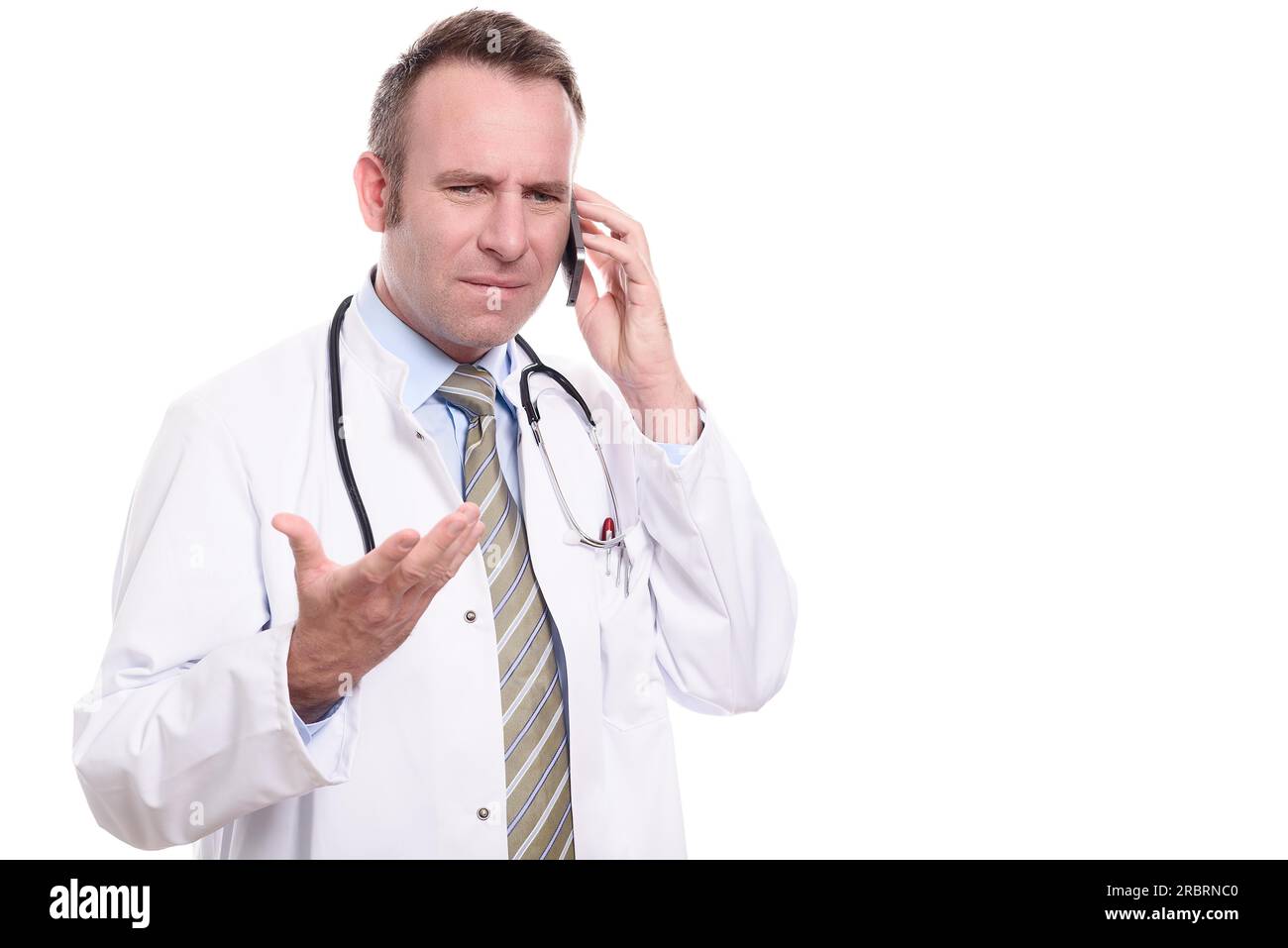 Puzzled doctor talking on a mobile phone gesturing with his hand and ...